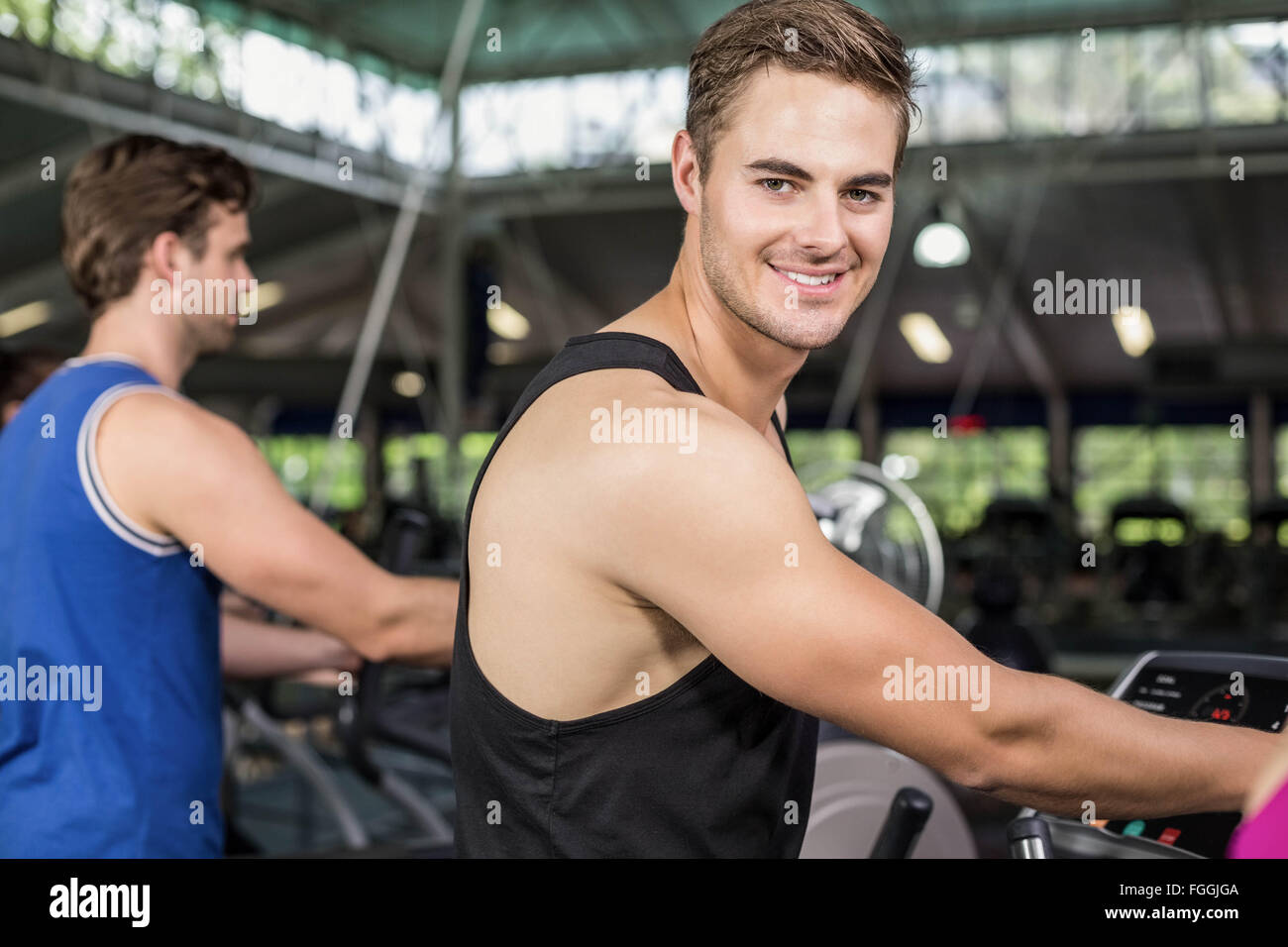 Fit man on elliptical bike Stock Photo - Alamy