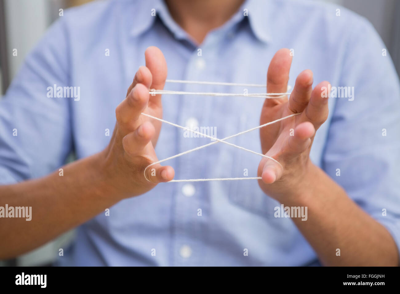 Mid section of man holding tangled string Stock Photo - Alamy