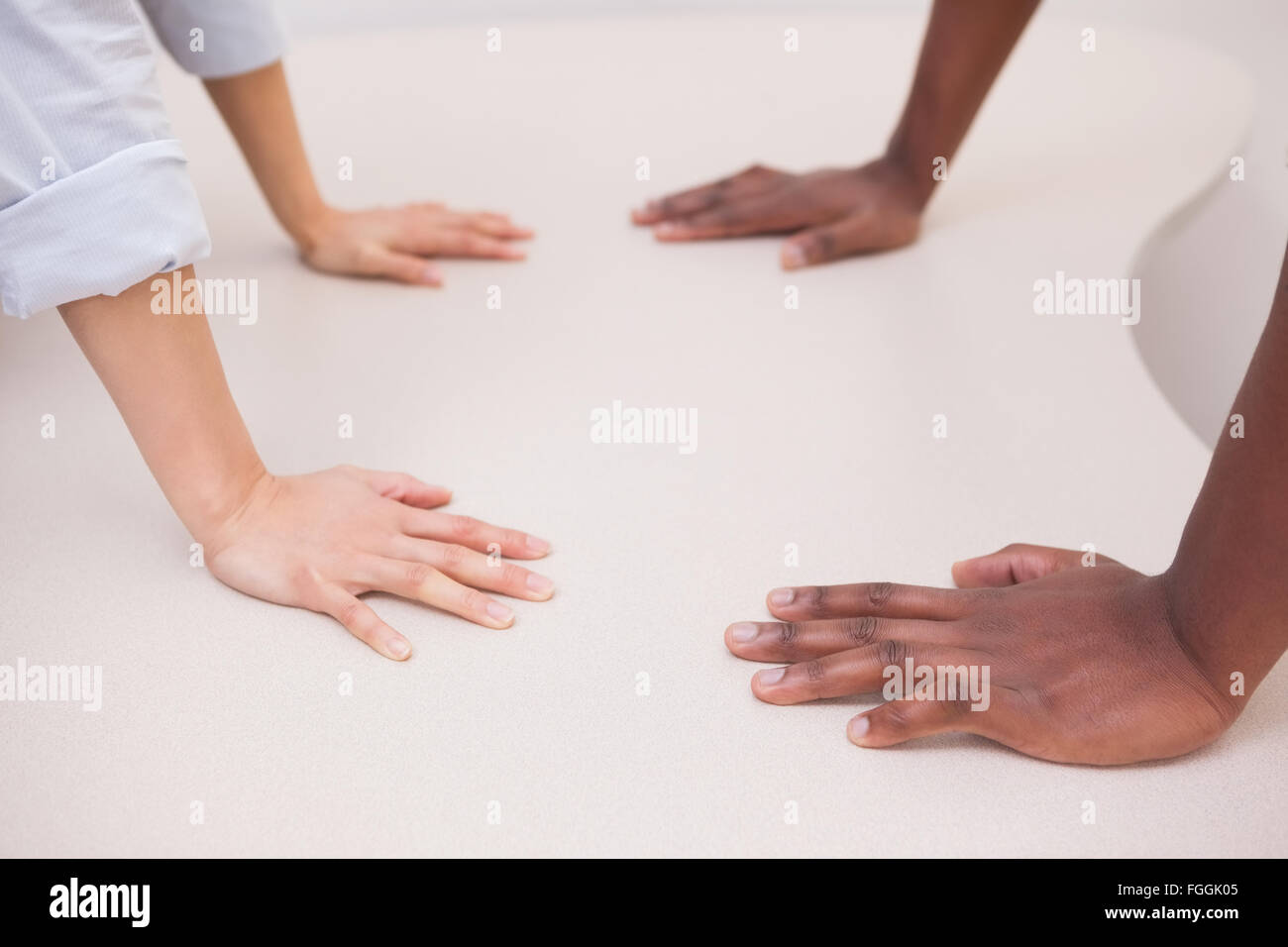 Casual business colleagues with hands on desk Stock Photo - Alamy