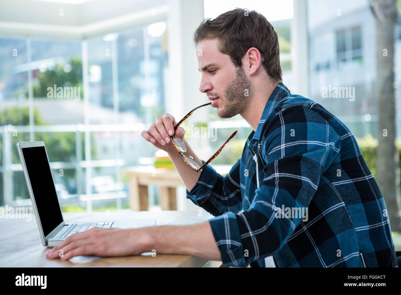 Handsome man working on laptop Stock Photo - Alamy