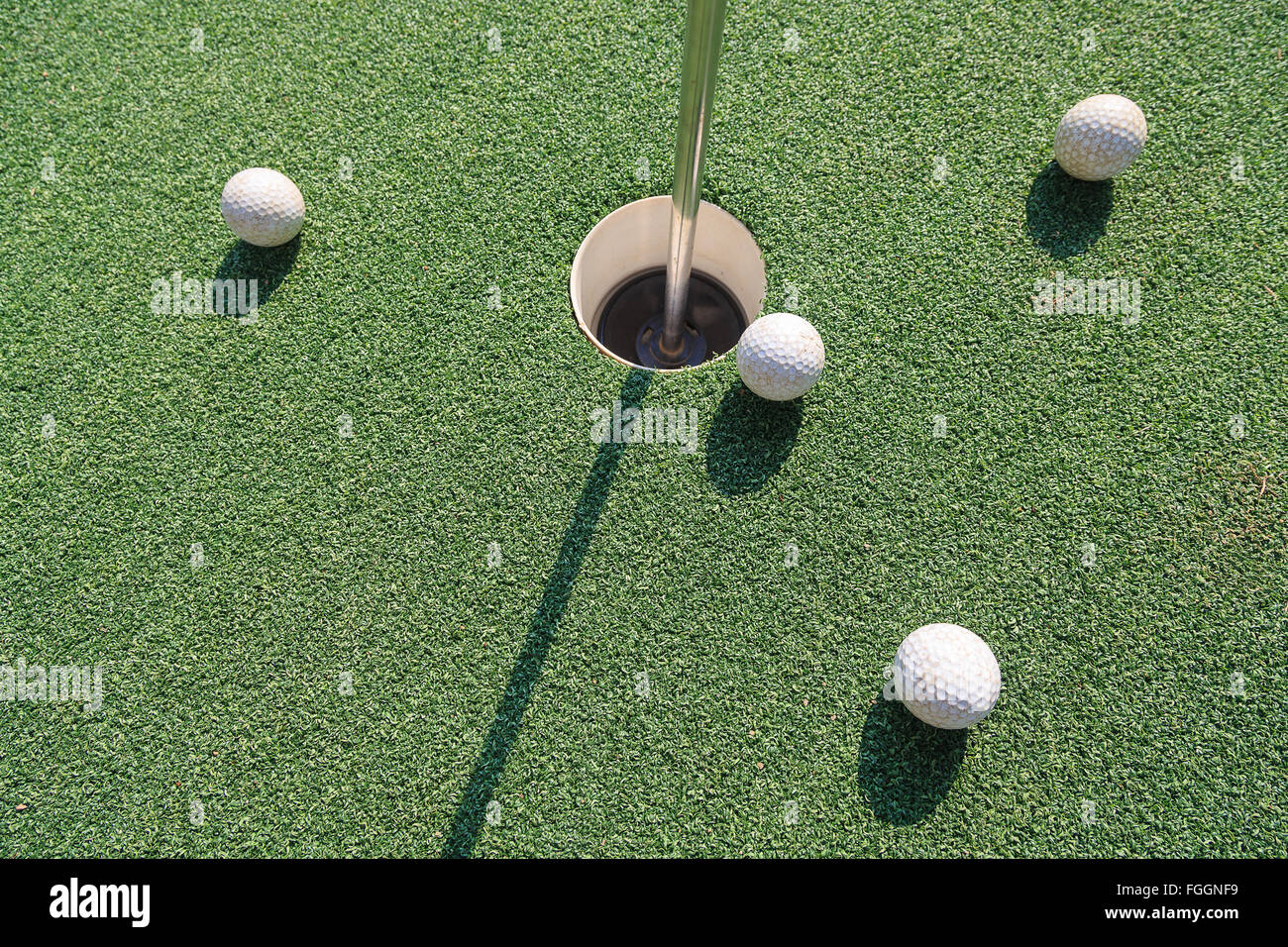 Golf three balls near hole hi-res stock photography and images - Alamy