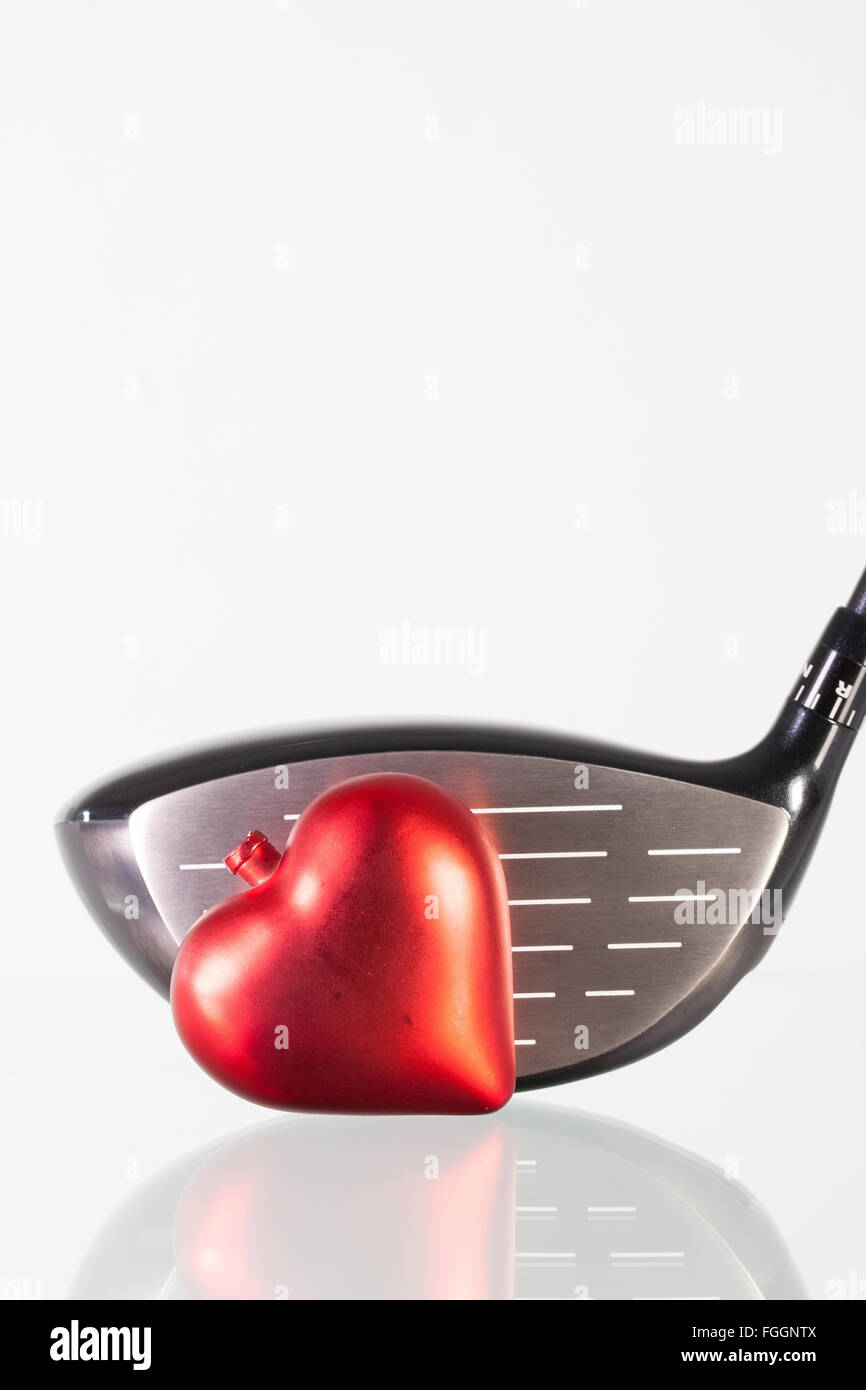 Golf club and red heart on a glass desk Stock Photo - Alamy