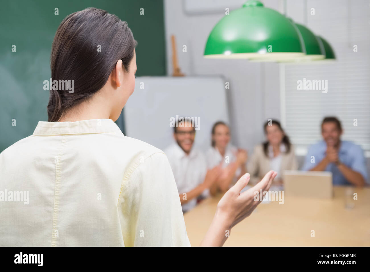Smiling businesswoman giving presentation to her colleagues Stock Photo ...