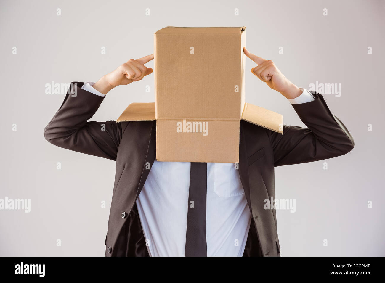 Anonymous businessman pointing to box Stock Photo - Alamy