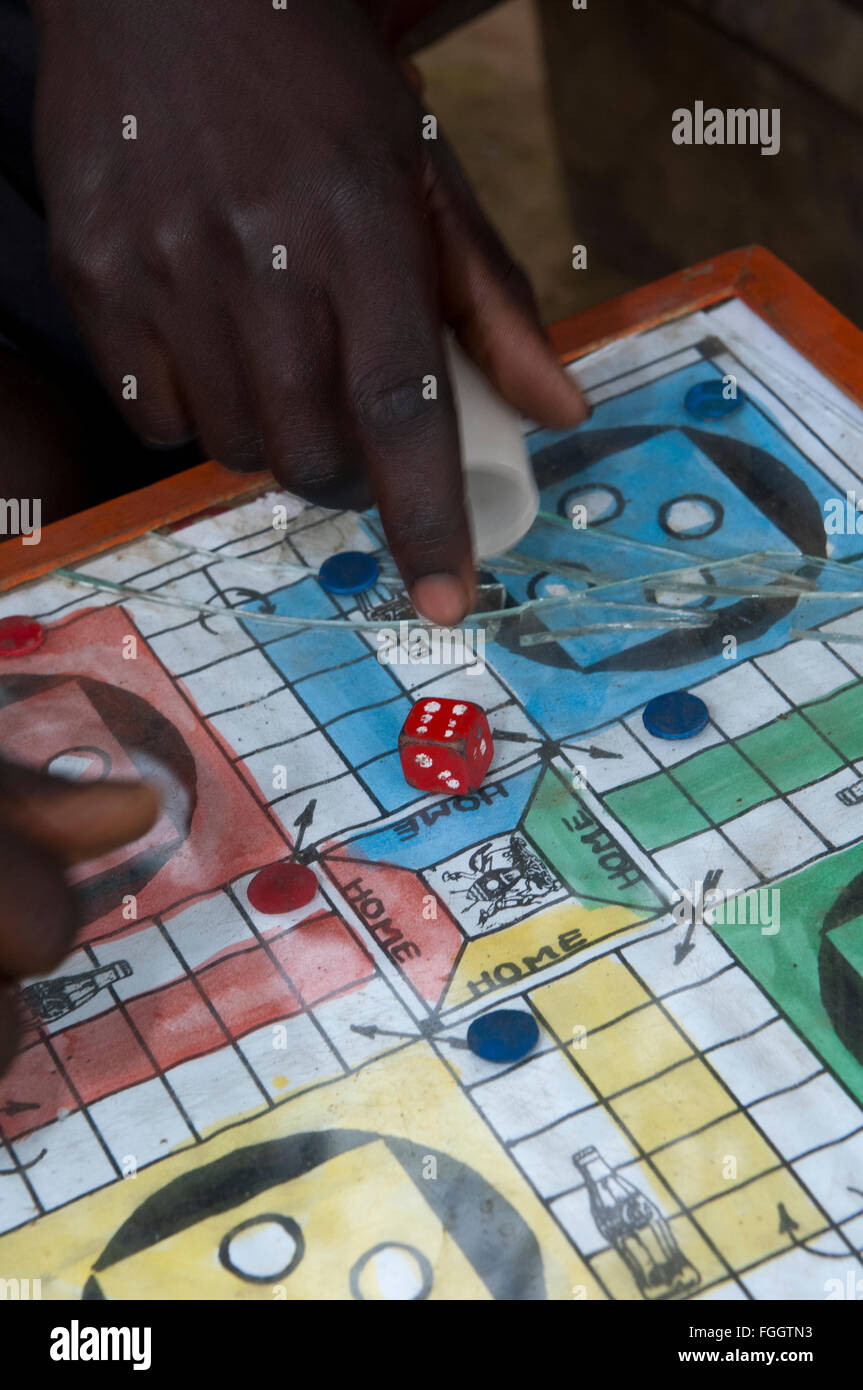 Ugandan boys playing a board game with dice Stock Photo - Alamy