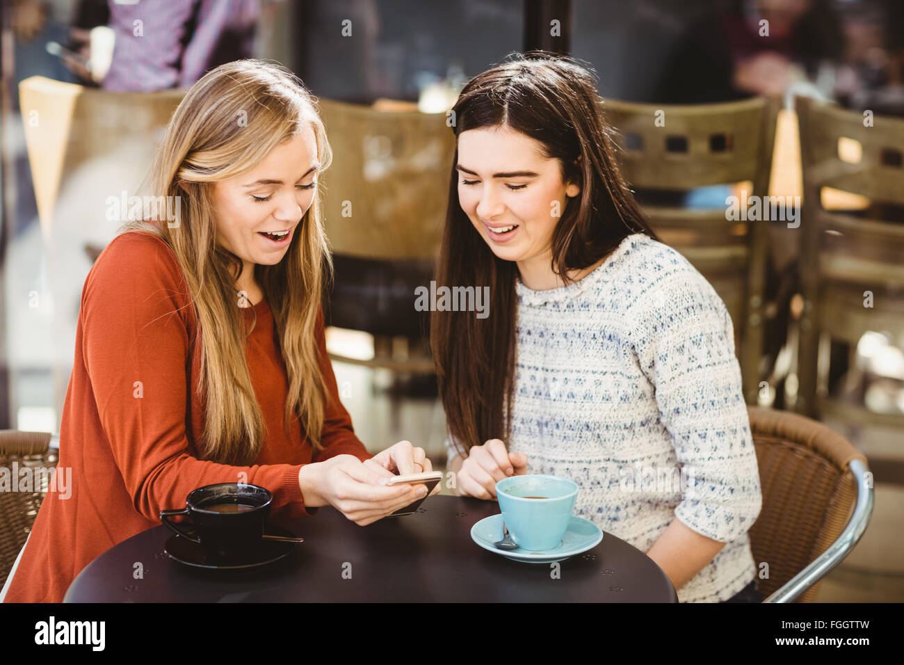 Friends looking at smartphone Stock Photo - Alamy