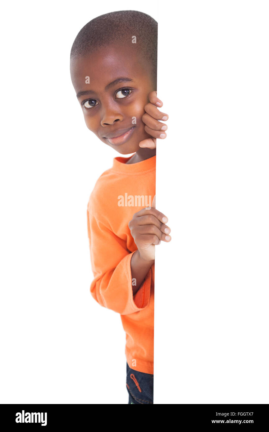 Cute boy looking around corner Stock Photo - Alamy