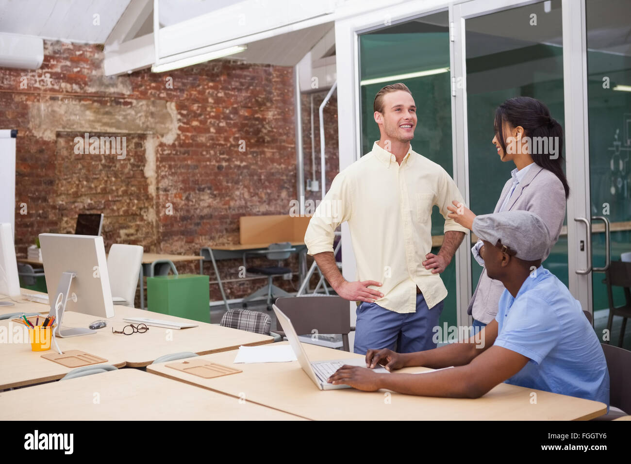 Three happy businessmen working together on a laptop Stock Photo - Alamy