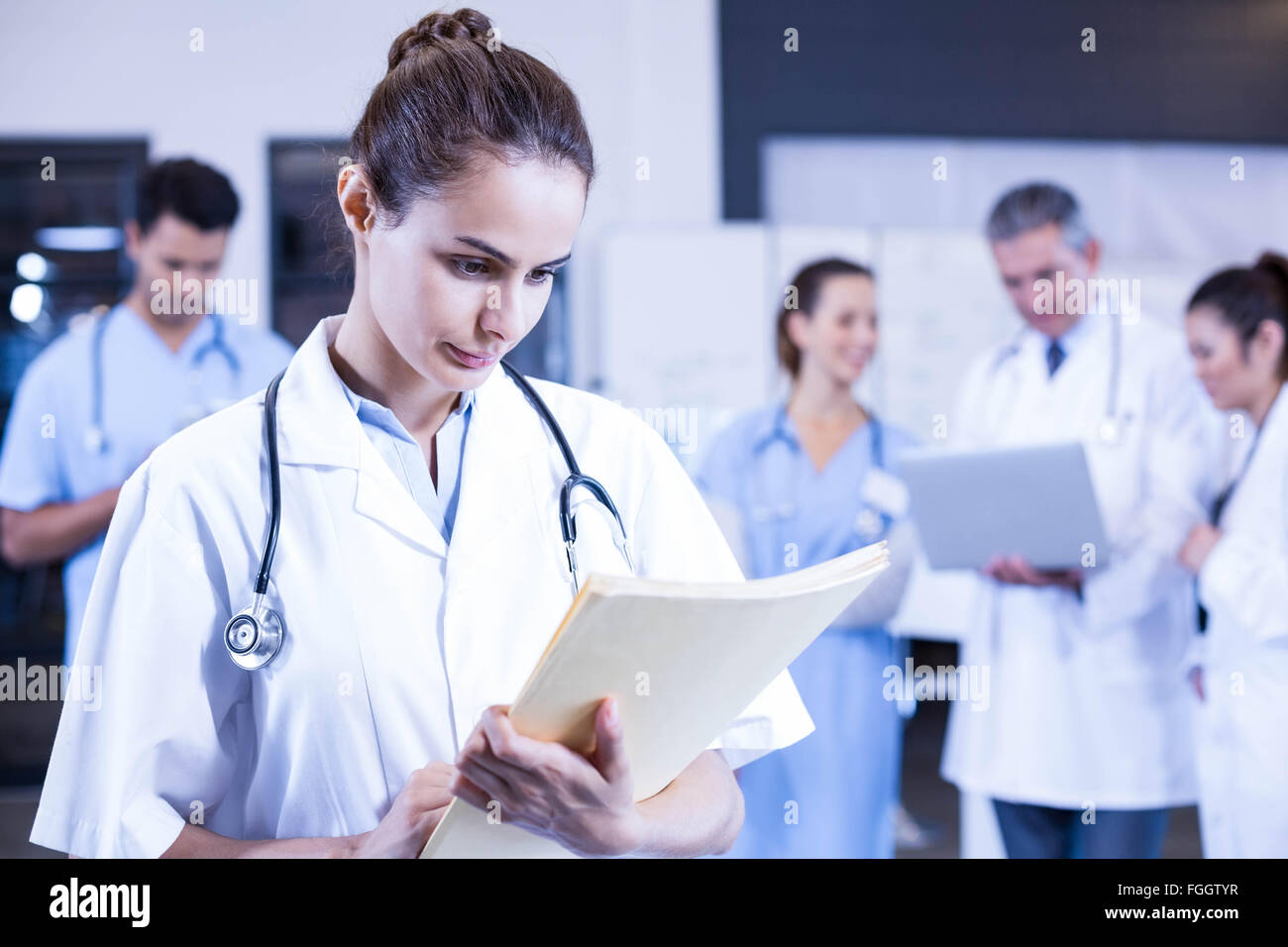 Female doctor checking a medical report Stock Photo - Alamy