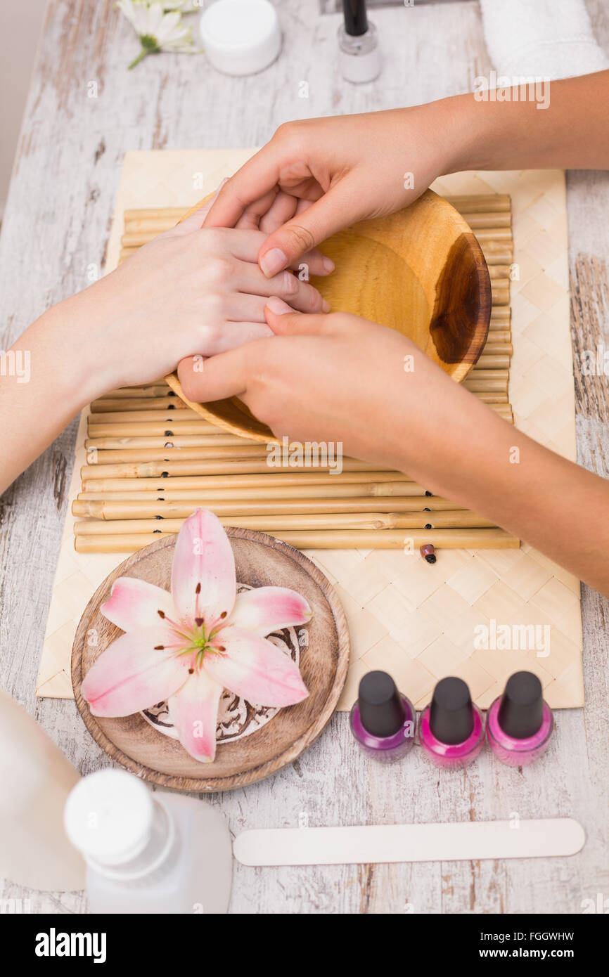 Nail technician giving customer a manicure Stock Photo - Alamy