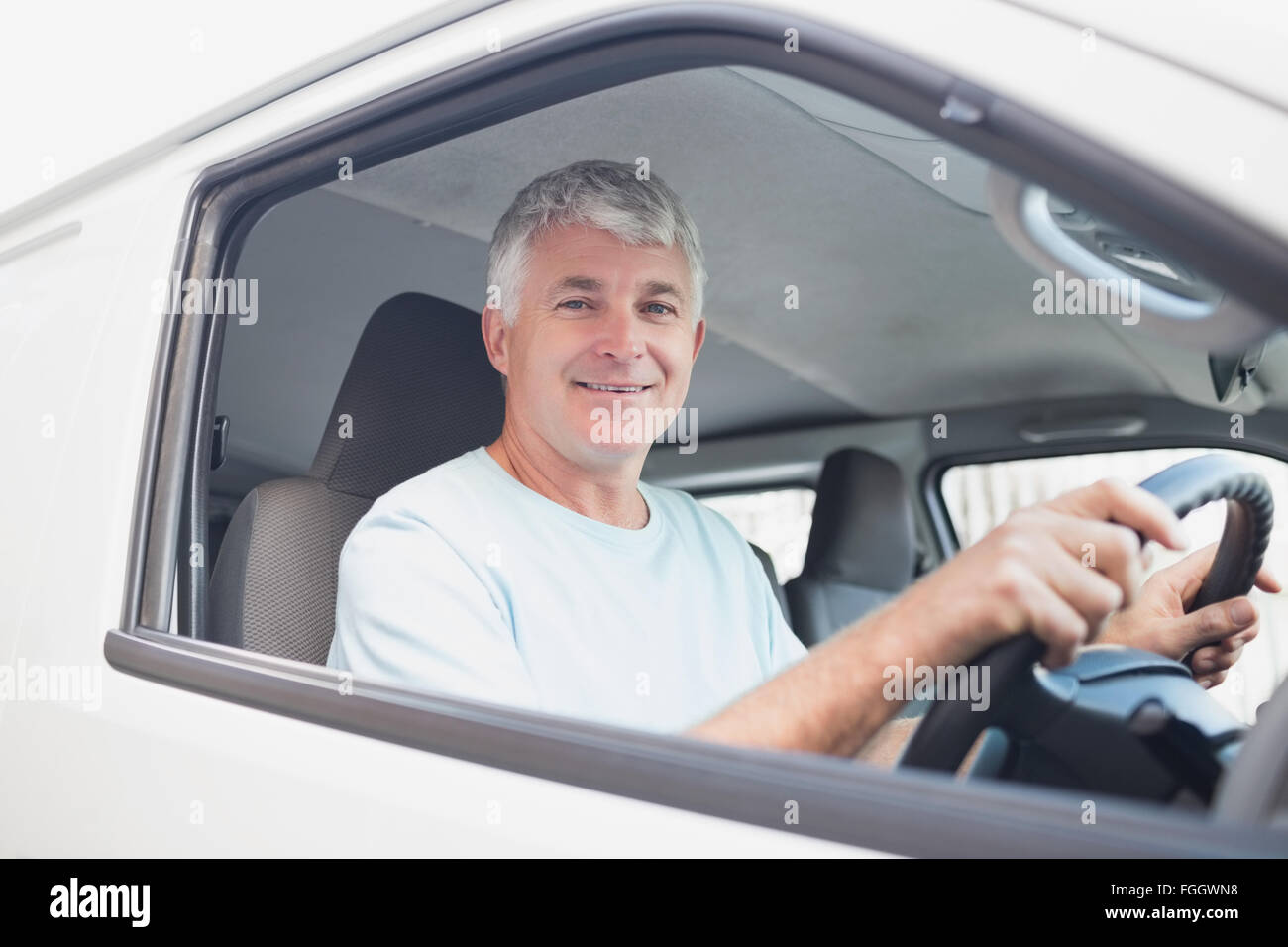 Smiling man driving van Stock Photo - Alamy