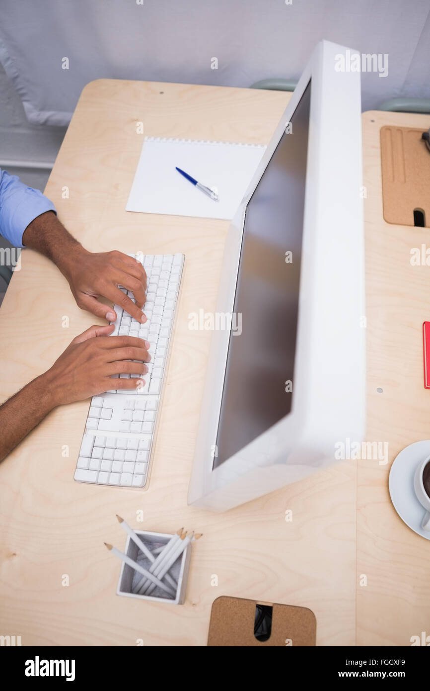 Hands using keyboard at desk Stock Photo - Alamy