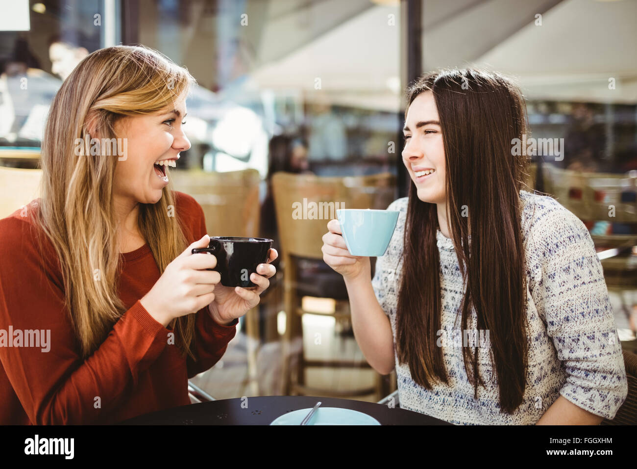 Friends chatting over coffee Stock Photo - Alamy