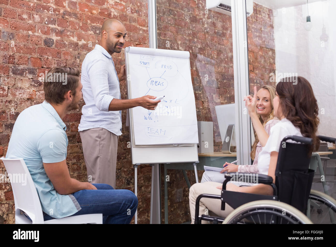 Businessman making a presentation to his fellow coworkers Stock Photo ...