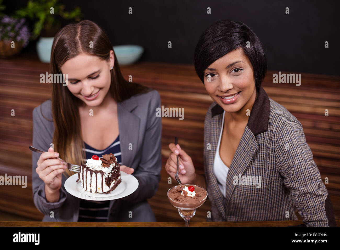 Pretty women eating desserts Stock Photo - Alamy