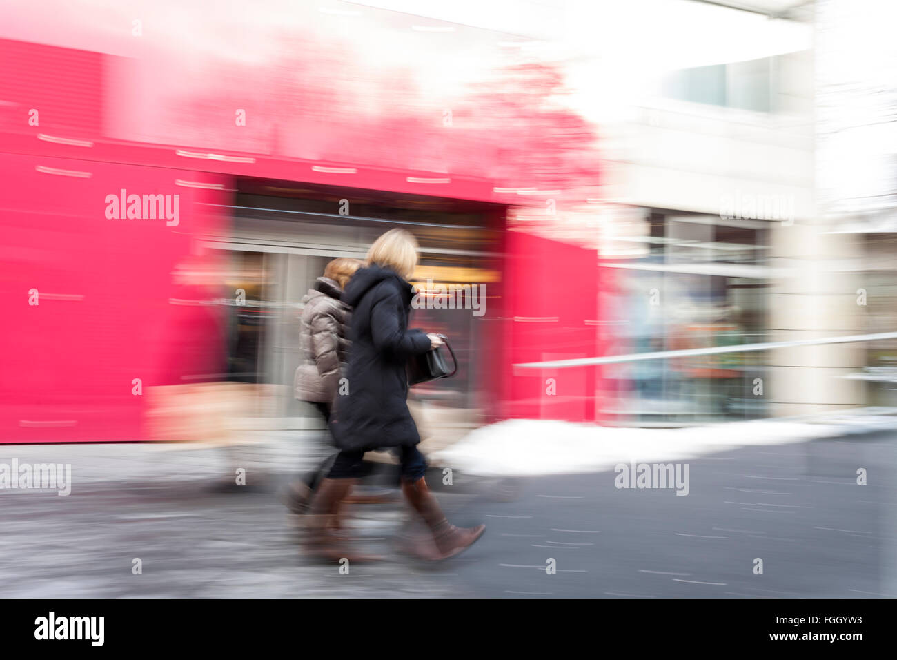 A shopper walking against shop window Stock Photo - Alamy
