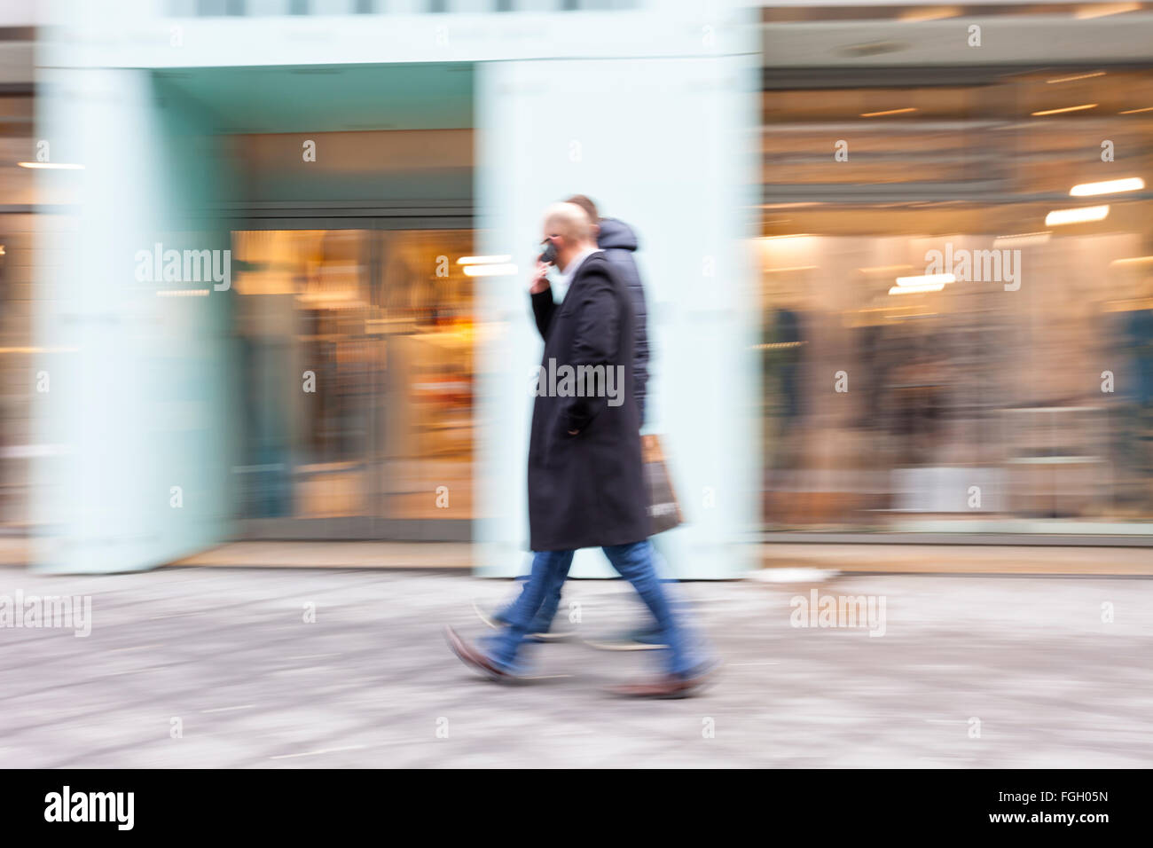 A shopper walking against shop window Stock Photo - Alamy