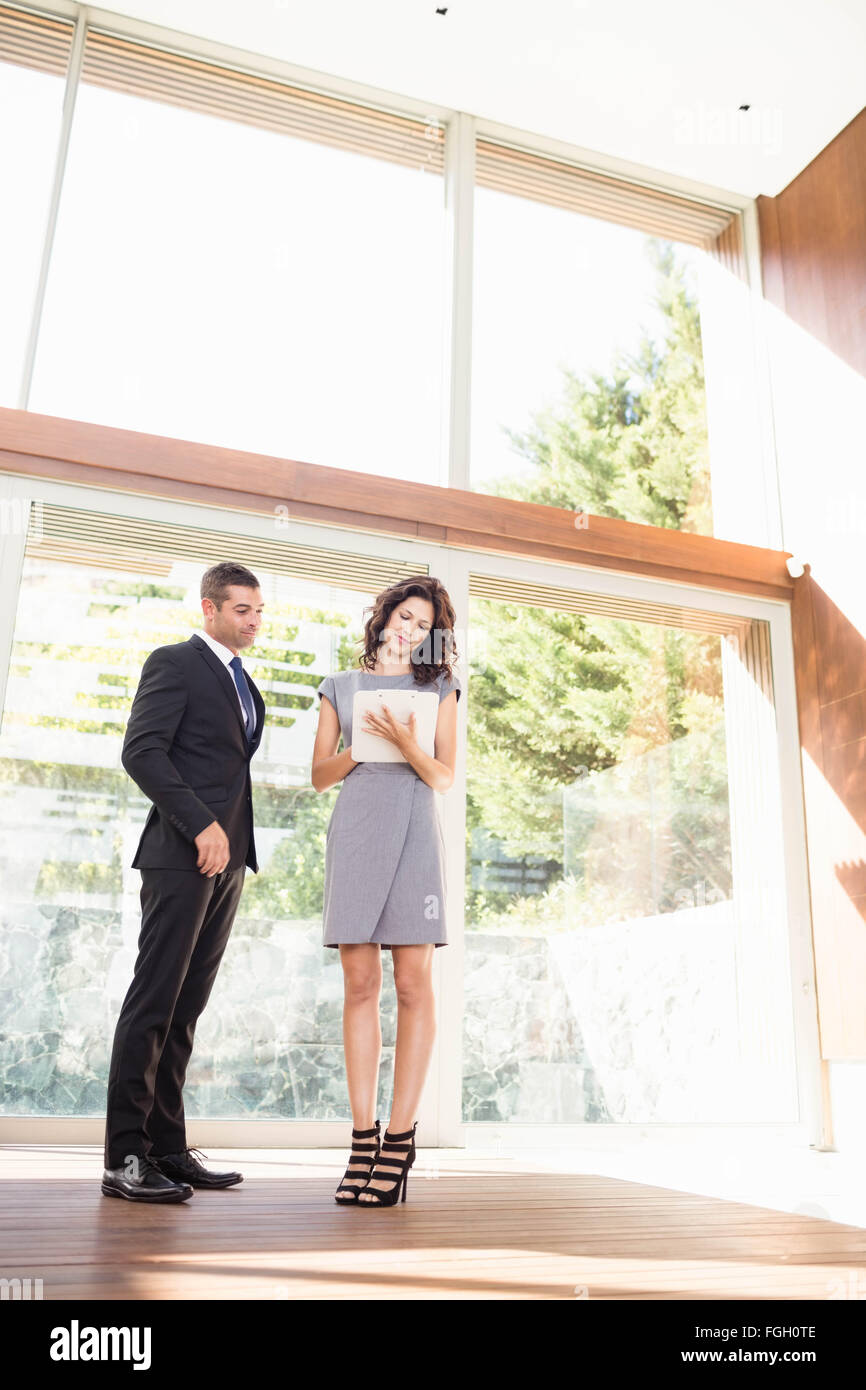 Real-estate agent showing young woman new home Stock Photo - Alamy