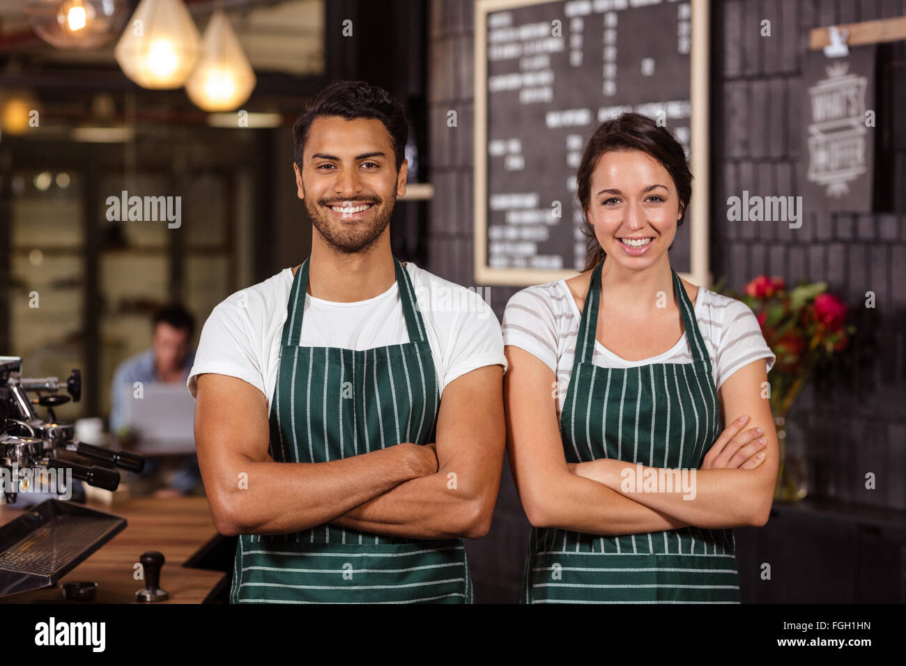 Smiling baristas standing with arms crossed Stock Photo - Alamy