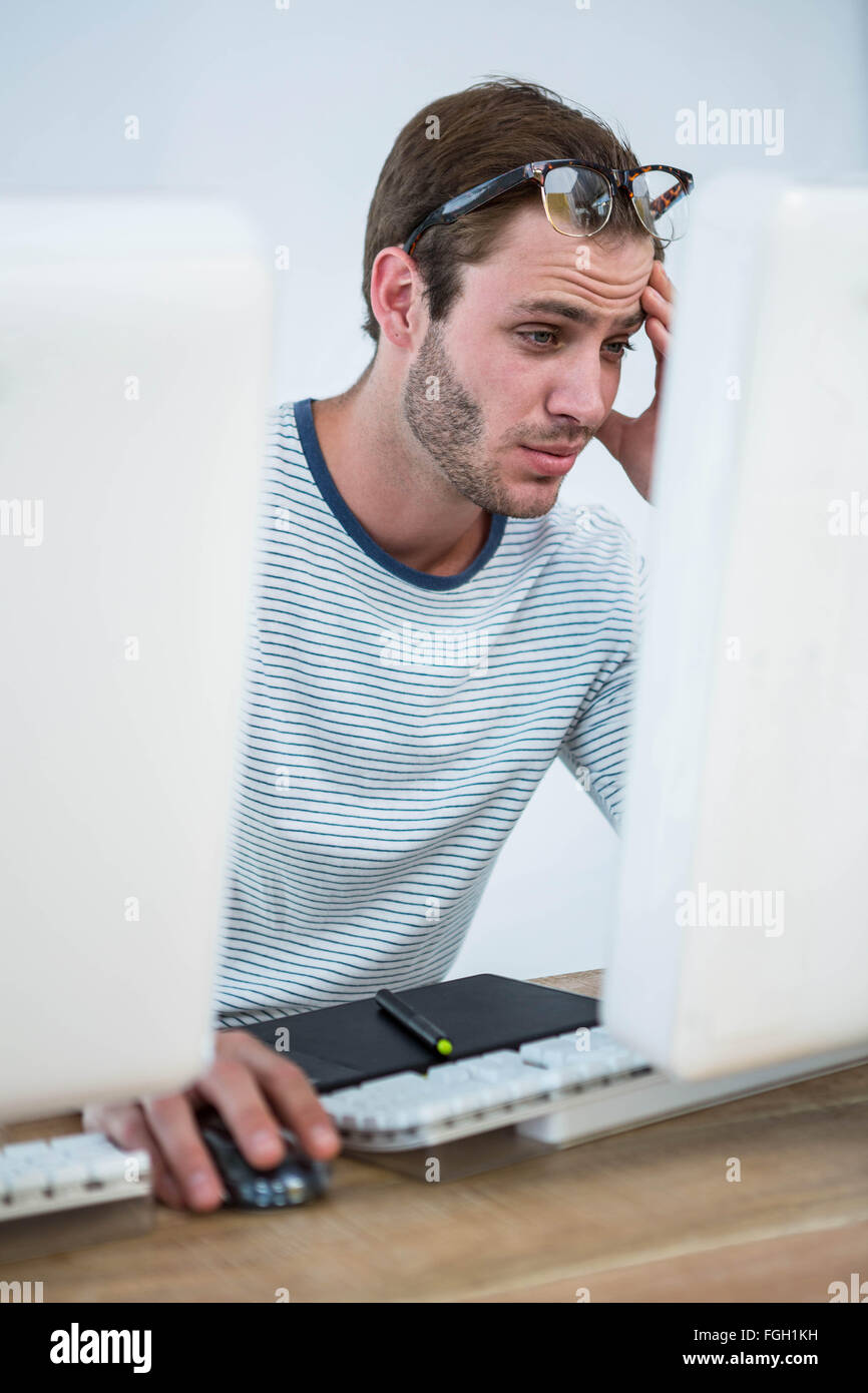 Tired man working on computer Stock Photo - Alamy