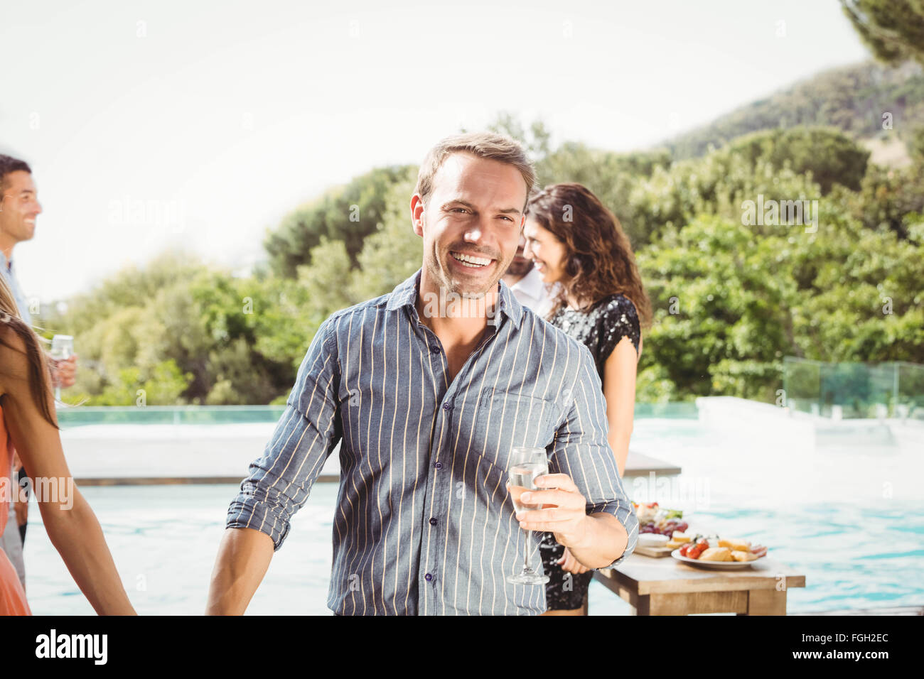 Happy young man having drinks Stock Photo - Alamy
