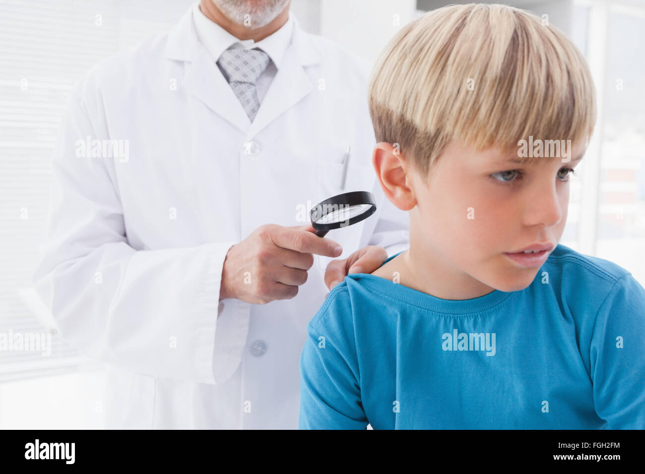 Doctor examining patient with magnifying glass Stock Photo - Alamy