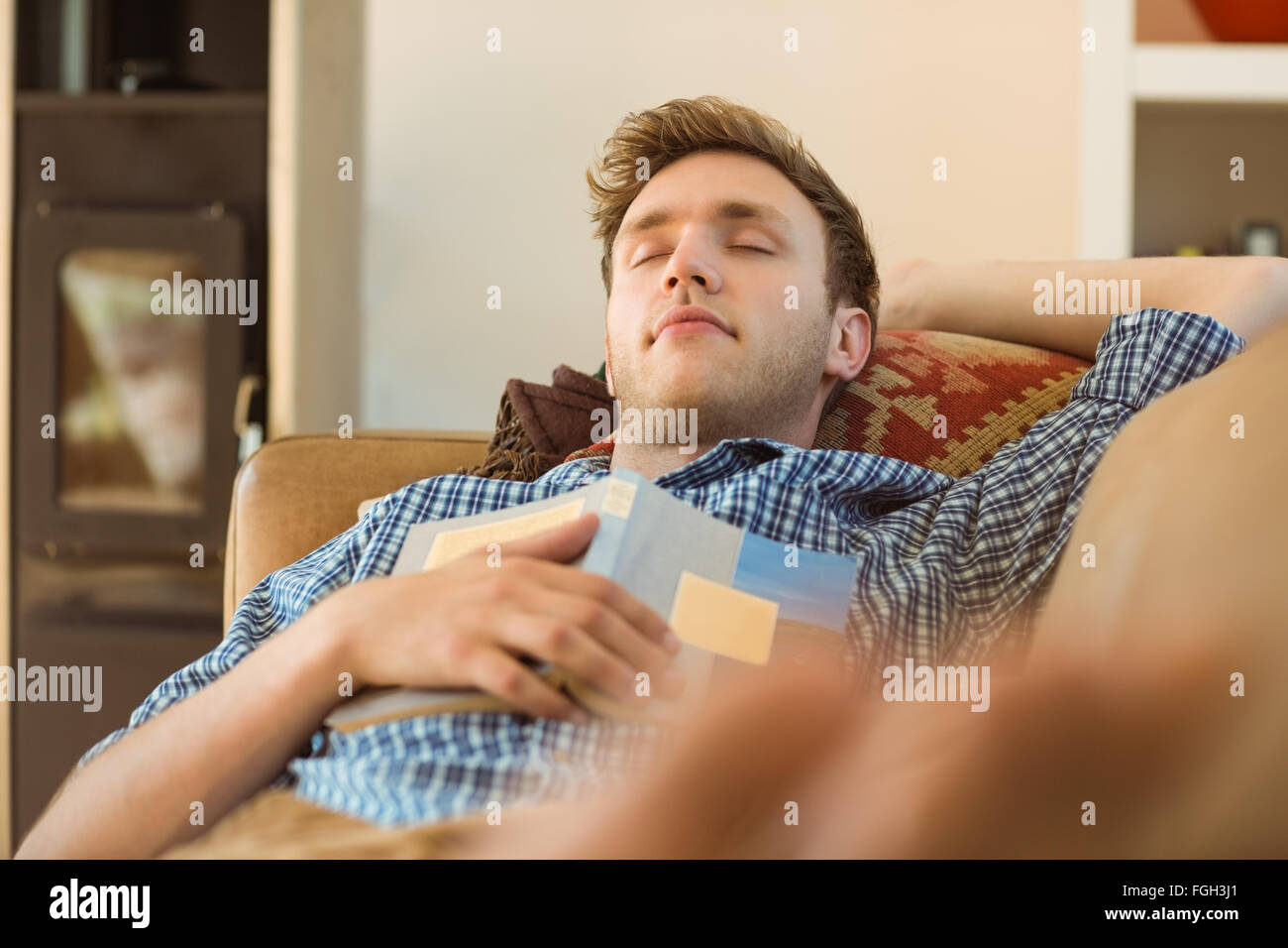 Young man napping on his couch Stock Photo - Alamy