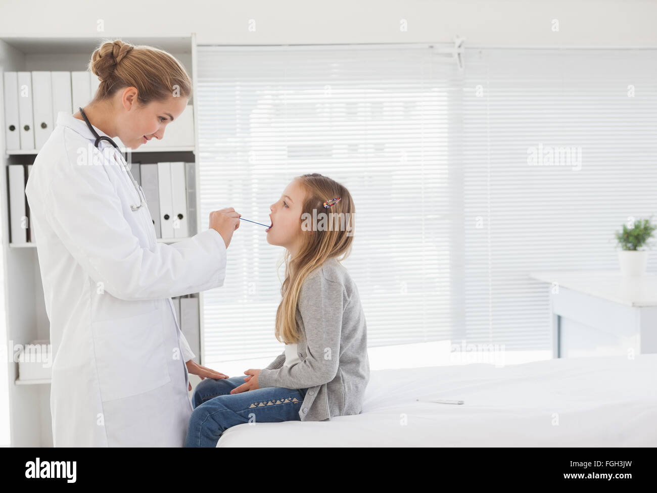 Doctor giving patient a check up Stock Photo - Alamy