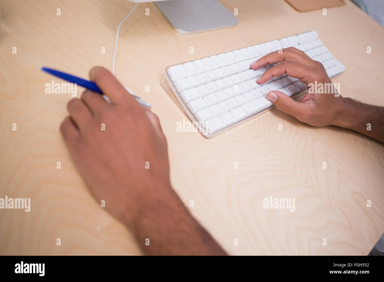 Hands using keyboard and mouse at desk Stock Photo - Alamy