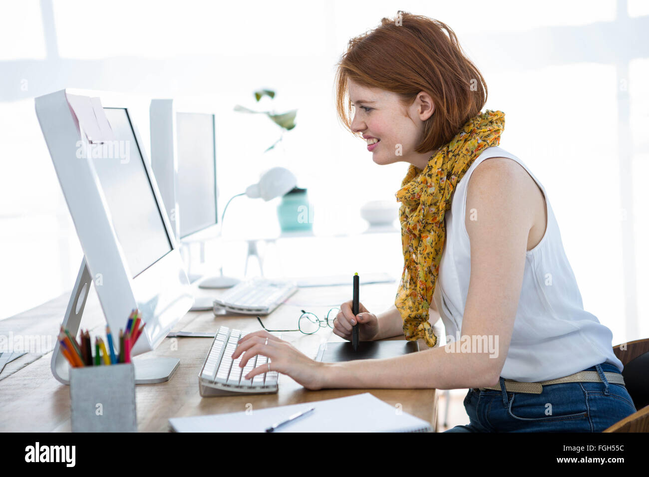 smiling hipster business woman typing on her computer Stock Photo - Alamy