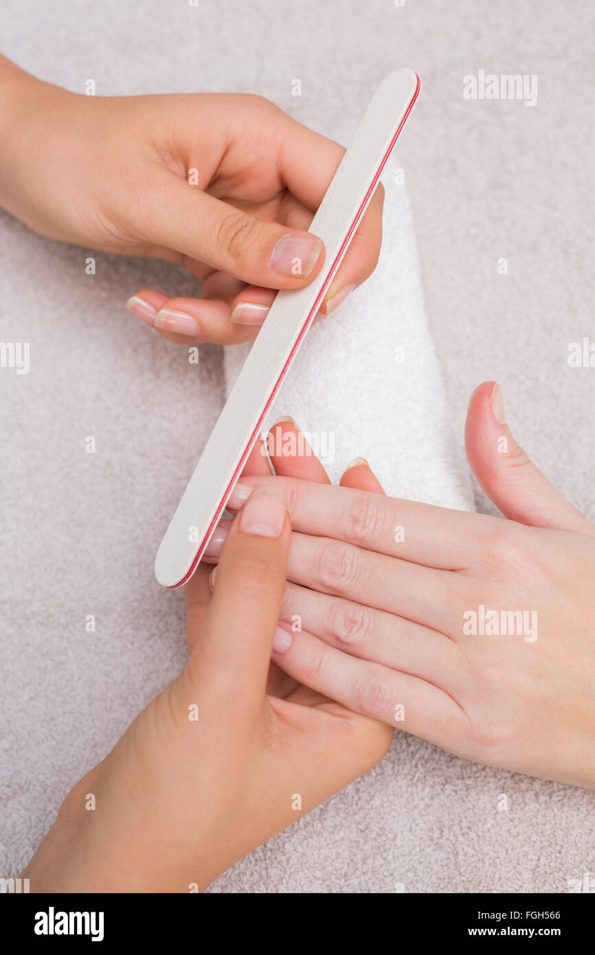 Nail technician giving customer a manicure Stock Photo - Alamy
