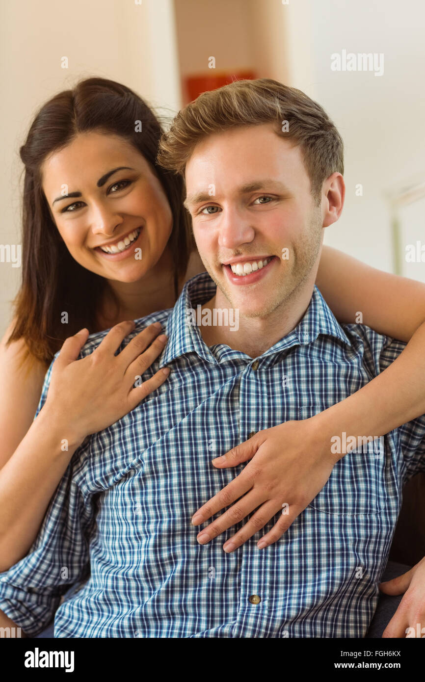 Happy young couple relaxing on the couch Stock Photo - Alamy