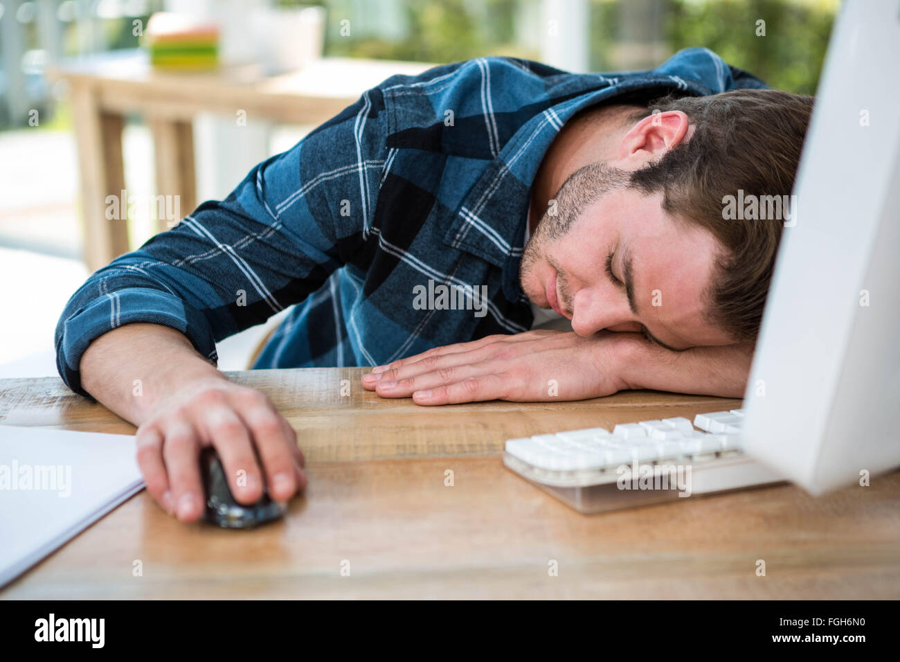 Handsome man sleeping on computer Stock Photo - Alamy