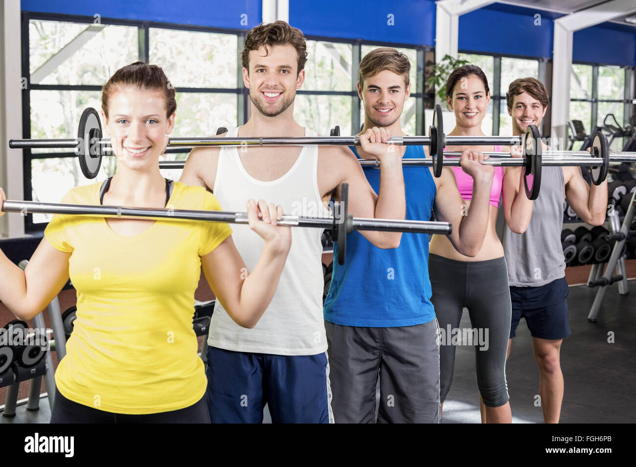 Fitness class lifting barbell Stock Photo - Alamy
