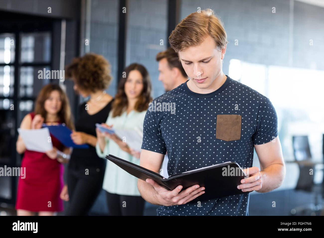Man reading a document in office Stock Photo - Alamy