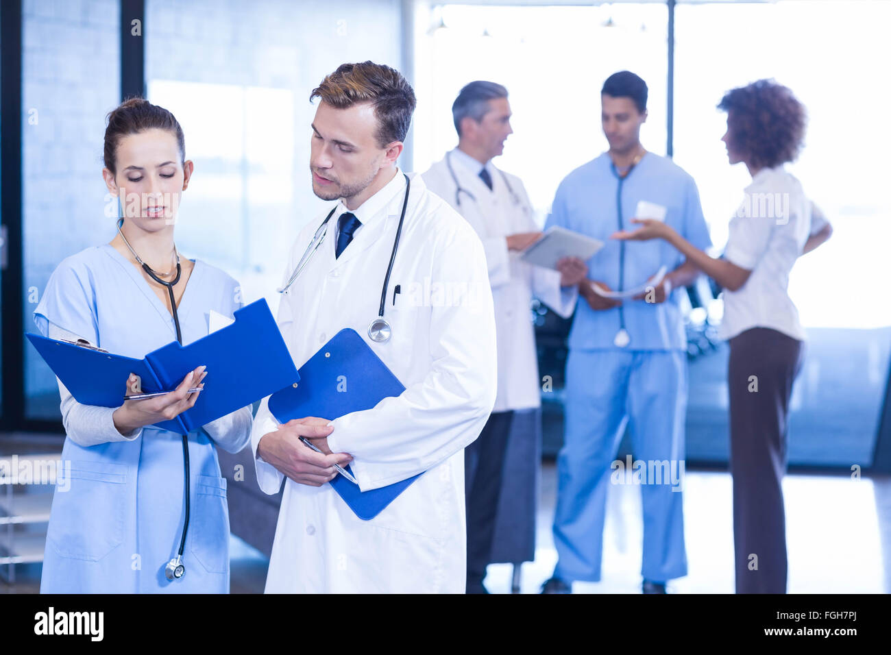 Doctors looking at medical report Stock Photo - Alamy