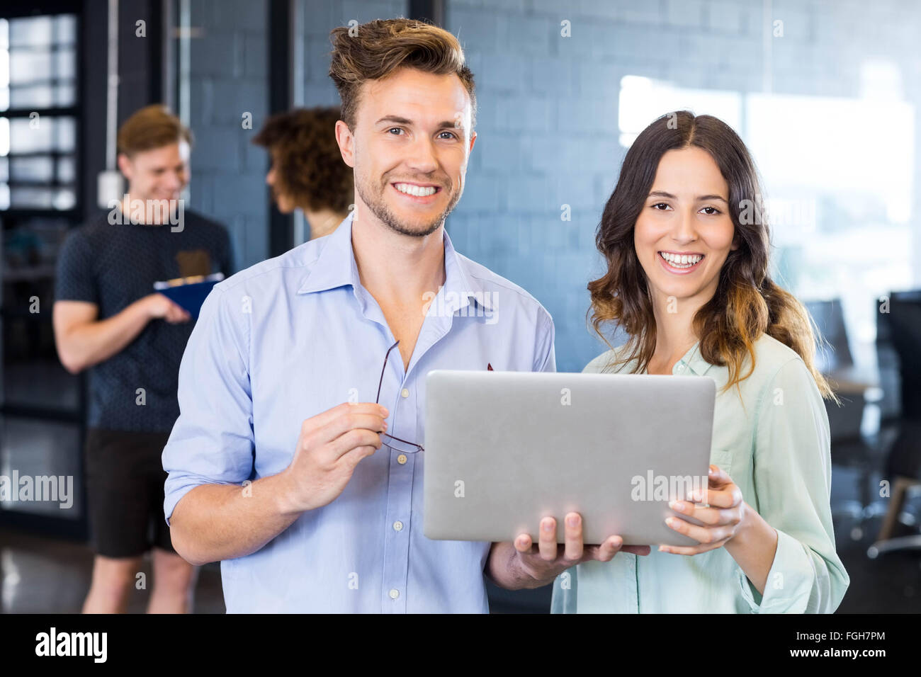 Standing office coworker showing laptop hi-res stock photography and ...