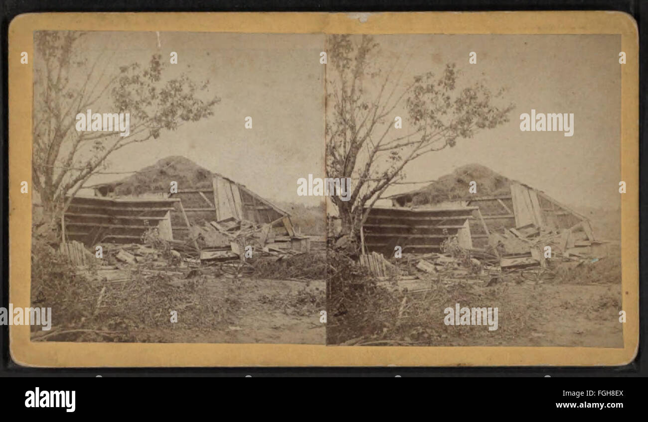A stereoscopic photograph showing a collapsed barn with a haystack ...