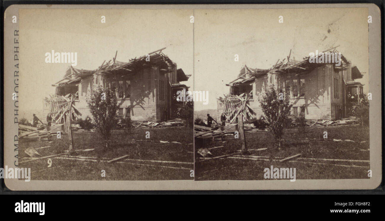 This photograph captures a collapsed house, highlighting the damage and ...