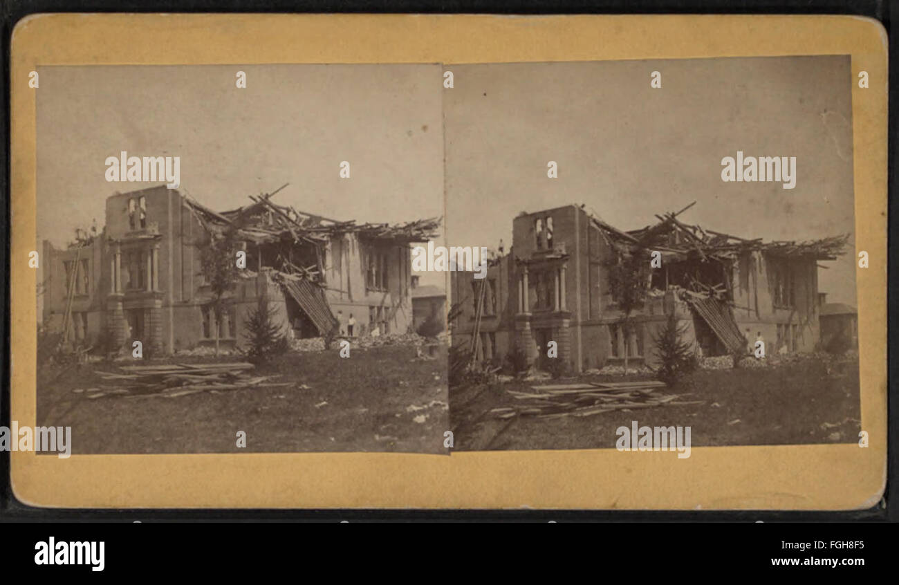 This photograph shows the aftermath of a collapsed three-story building ...