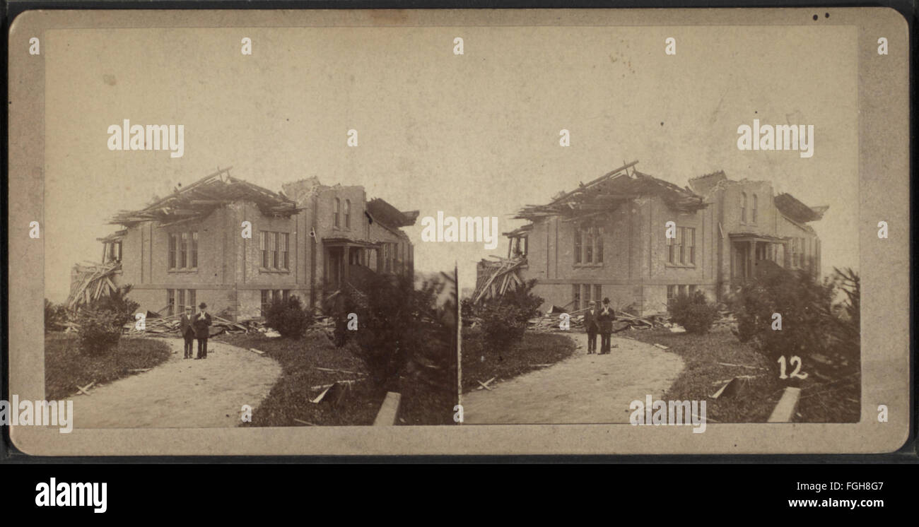 A photograph by Nicholas R. Worden showing a damaged house with a ...