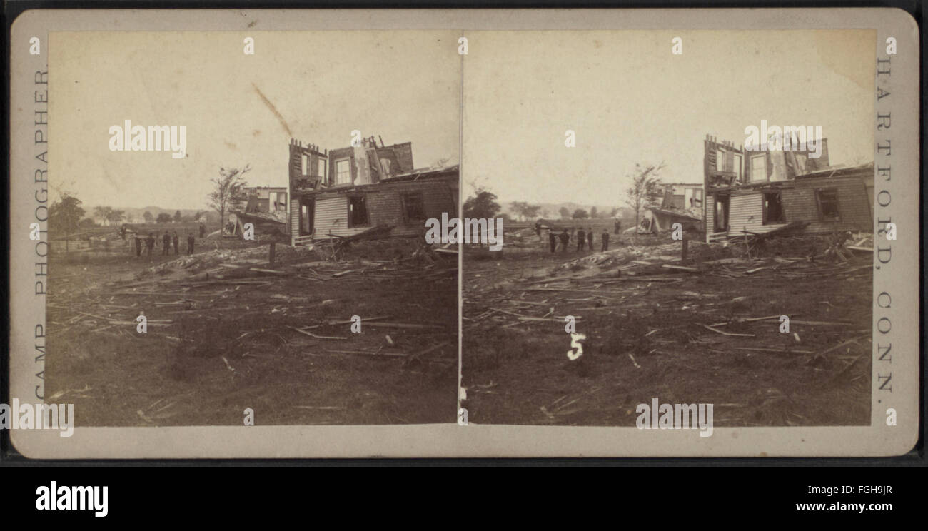 A photograph by D.S. Camp showing collapsed houses, depicting the ...