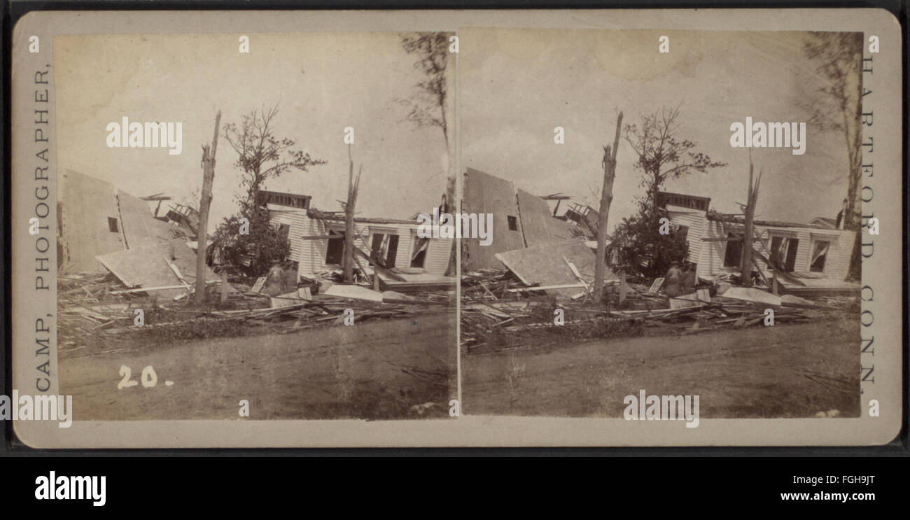 A photograph by Daniel S. Camp showing collapsed houses. The image ...