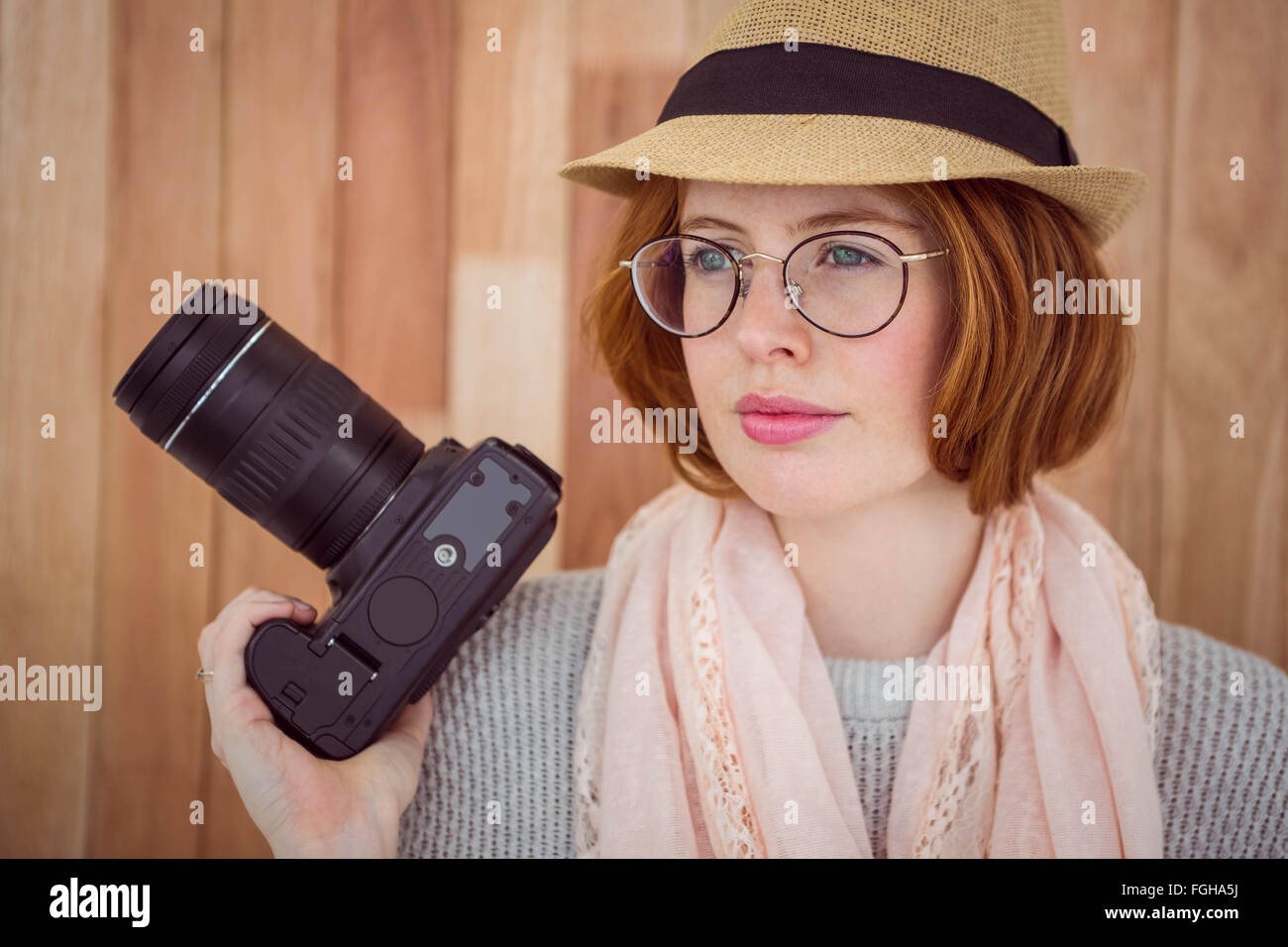 Hipster smiling and holding camera Stock Photo - Alamy