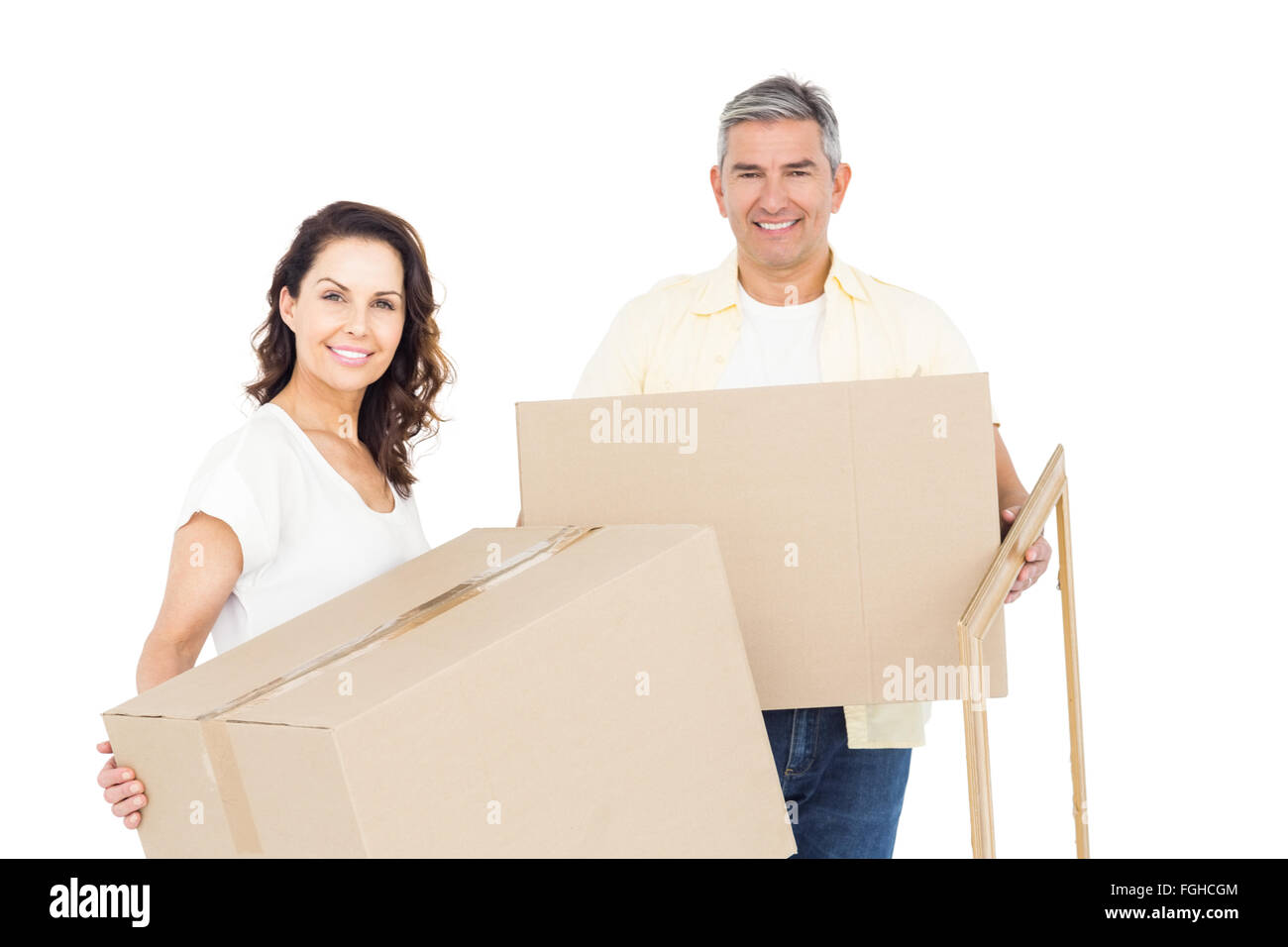 Happy couple carrying box Stock Photo - Alamy
