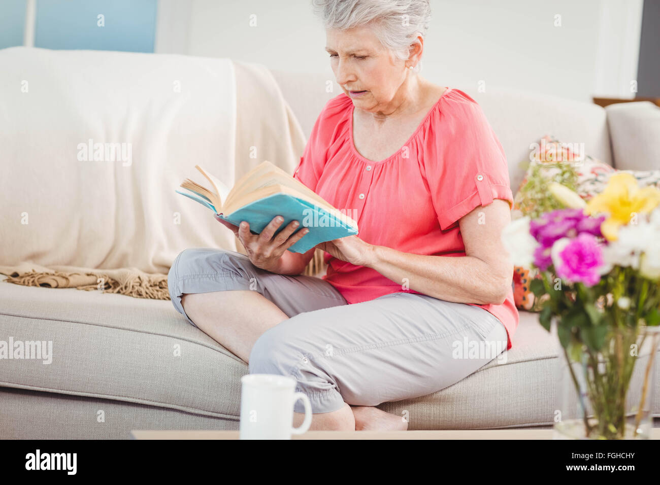 Senior woman reading a book Stock Photo - Alamy