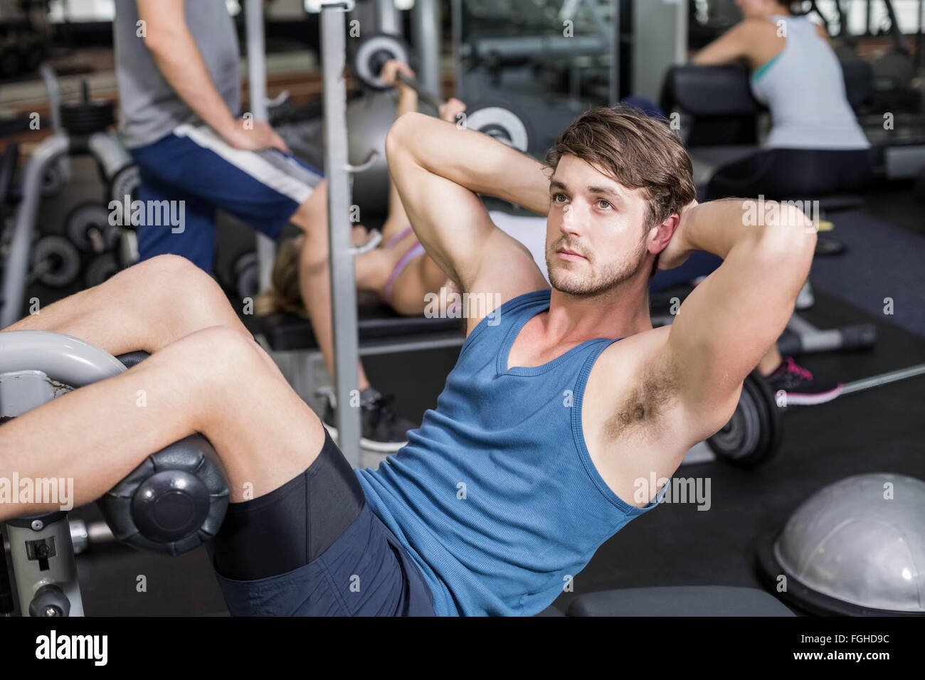 Handsome man working his abs Stock Photo - Alamy
