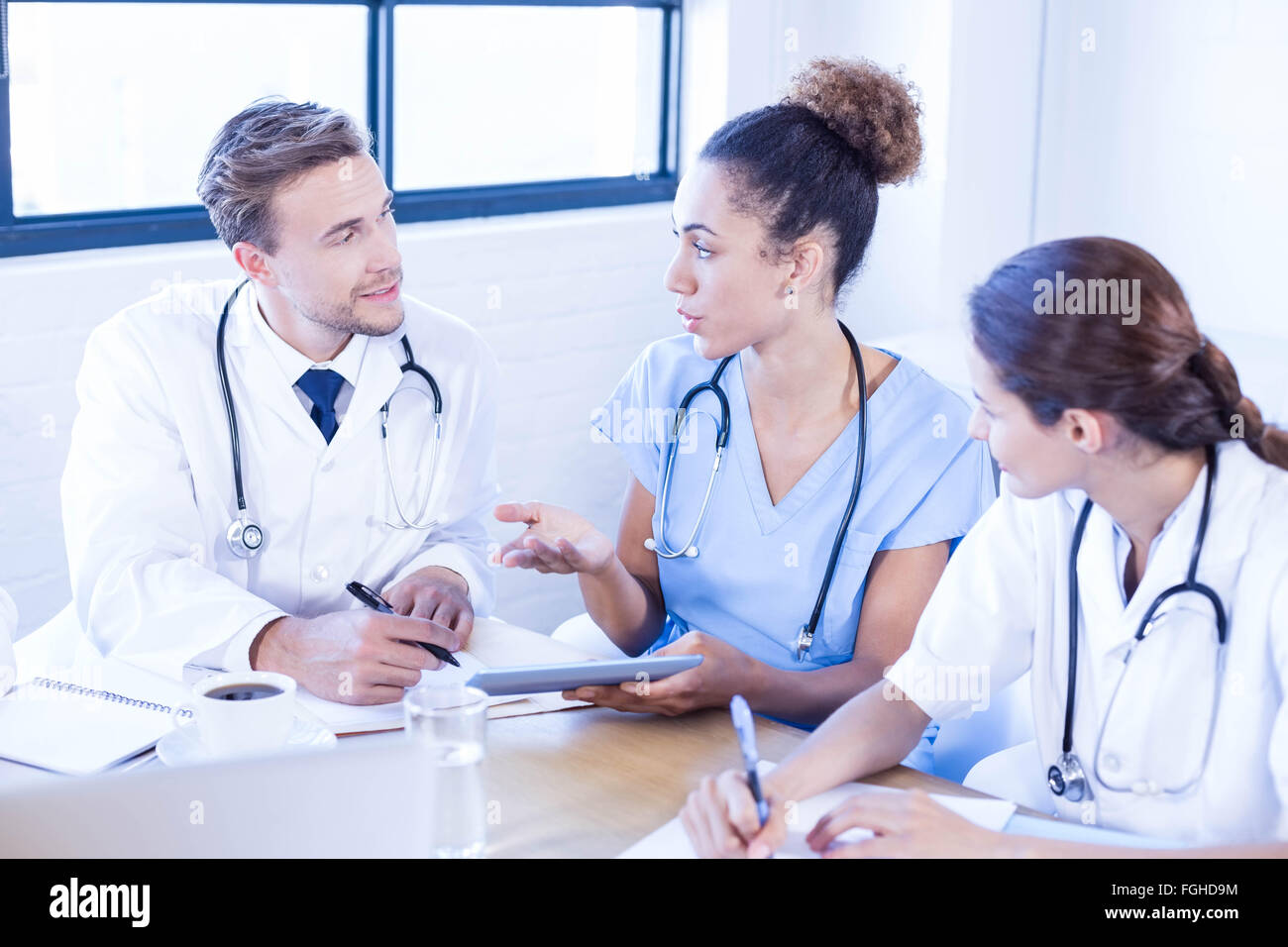 Medical team in meeting discussing hi-res stock photography and images ...