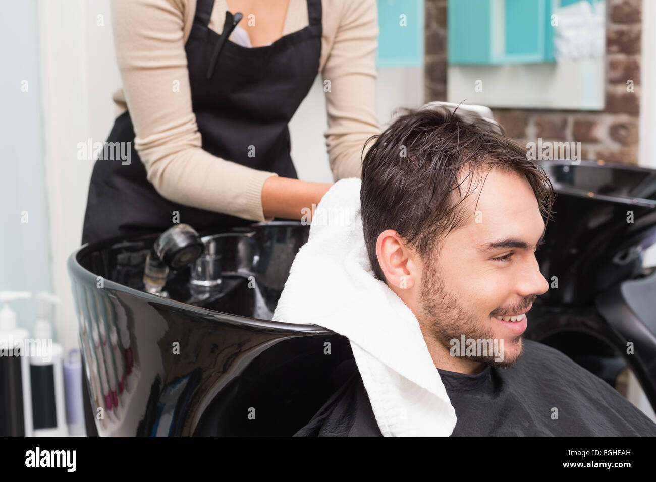 Hair stylist drying mans hair Stock Photo - Alamy