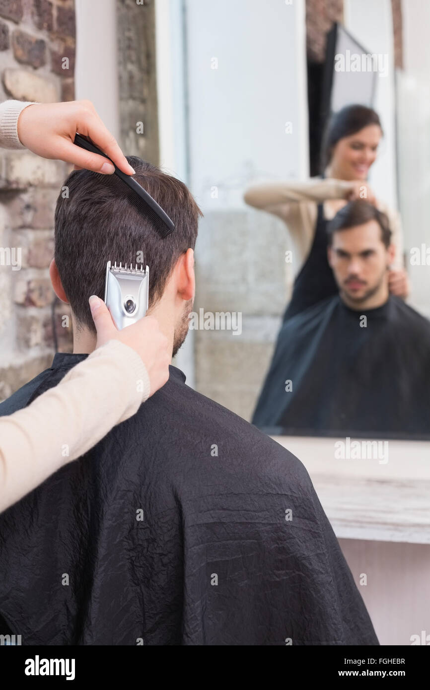 Handsome man getting his hair trimmed Stock Photo - Alamy